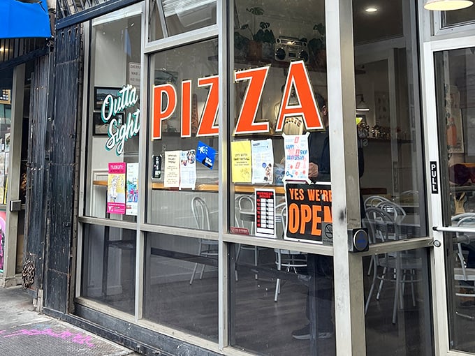 The neon promise of "Outta Sight Pizza" glows like a beacon for hungry San Franciscans. This unassuming storefront holds pizza treasures waiting to be discovered.