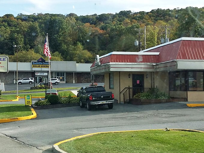 The classic red roof and American flag announce this diner's mission before you even step inside: authentic food without pretense.