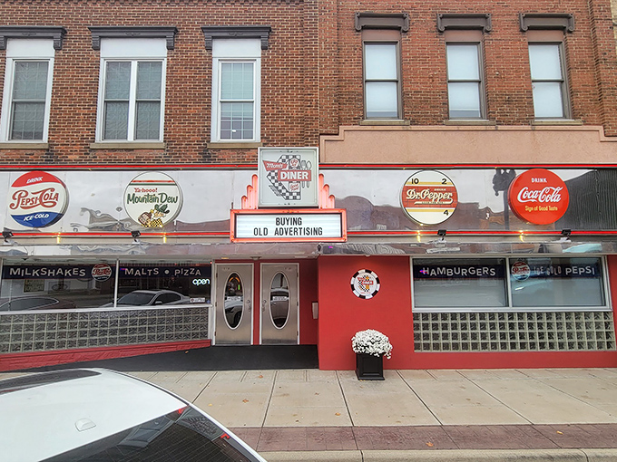The vibrant red exterior of Mom's Diner & Pizzeria stands out like a beacon of nostalgia, complete with those iconic oval doors straight from American Graffiti.