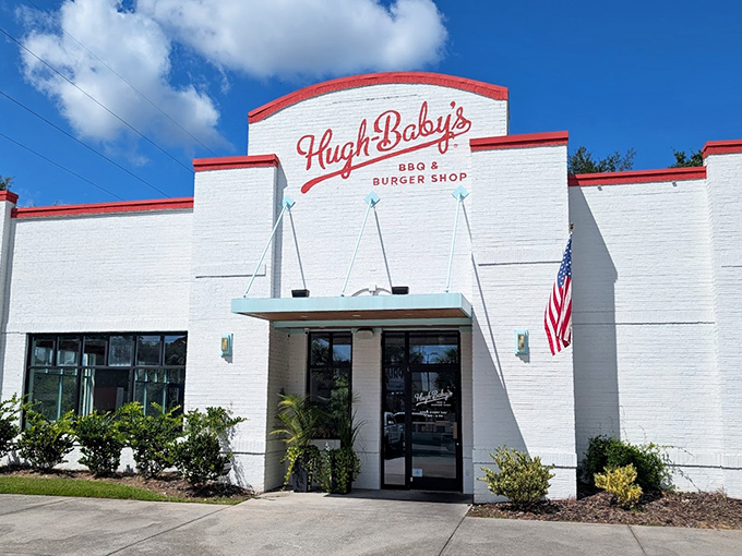 The white brick fortress of flavor! Hugh-Baby's crisp exterior with its bold red trim promises burger paradise before you even step inside.
