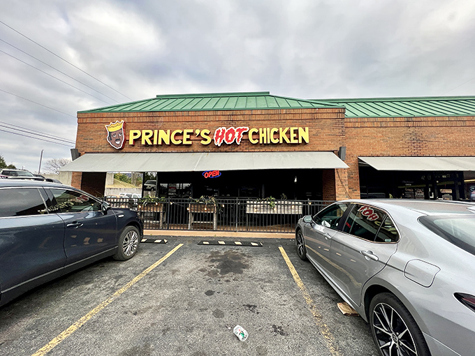 The brick facade of Prince's Hot Chicken Shack South stands like a temple to spice, beckoning heat-seekers with its iconic crown logo and fiery promise.