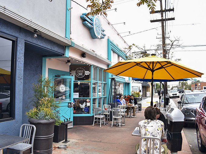 The turquoise trim and cheerful yellow umbrellas of Crest Cafe beckon like a culinary lighthouse in San Diego's vibrant Hillcrest neighborhood.