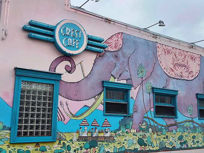 The turquoise-framed entrance to Crest Cafe stands out like a tropical oasis in Hillcrest, promising culinary adventures behind its welcoming doors.