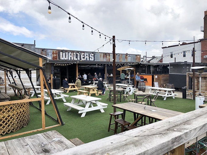 Rustic wooden beams, string lights, and stacked firewood – Walter's outdoor entrance isn't just welcoming, it's practically whispering "come get comfortable" in your ear.