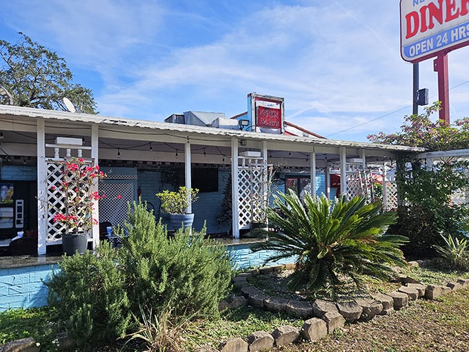 The classic red and blue sign beckons like a lighthouse for hungry souls&mdash;Joe's New York Diner stands ready to serve, 24 hours a day.