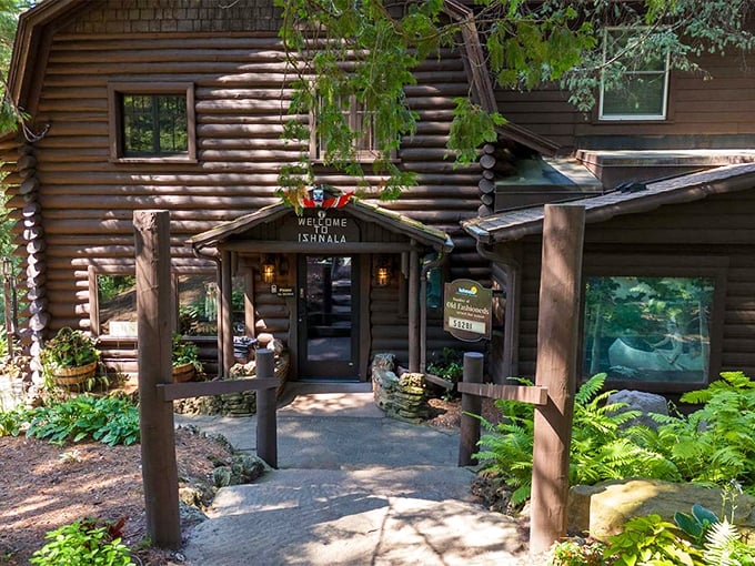Nature doesn't just surround Ishnala&mdash;it embraces it. This log cabin entrance, nestled among towering pines, promises wilderness luxury before you even step inside.