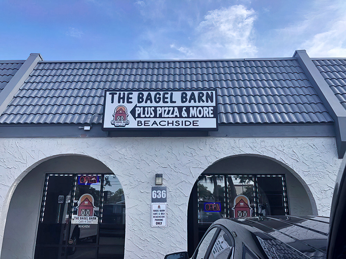 The blue-tiled roof and charming arched entryway of The Bagel Barn beckons like a carb-loaded oasis in the Florida strip mall desert.