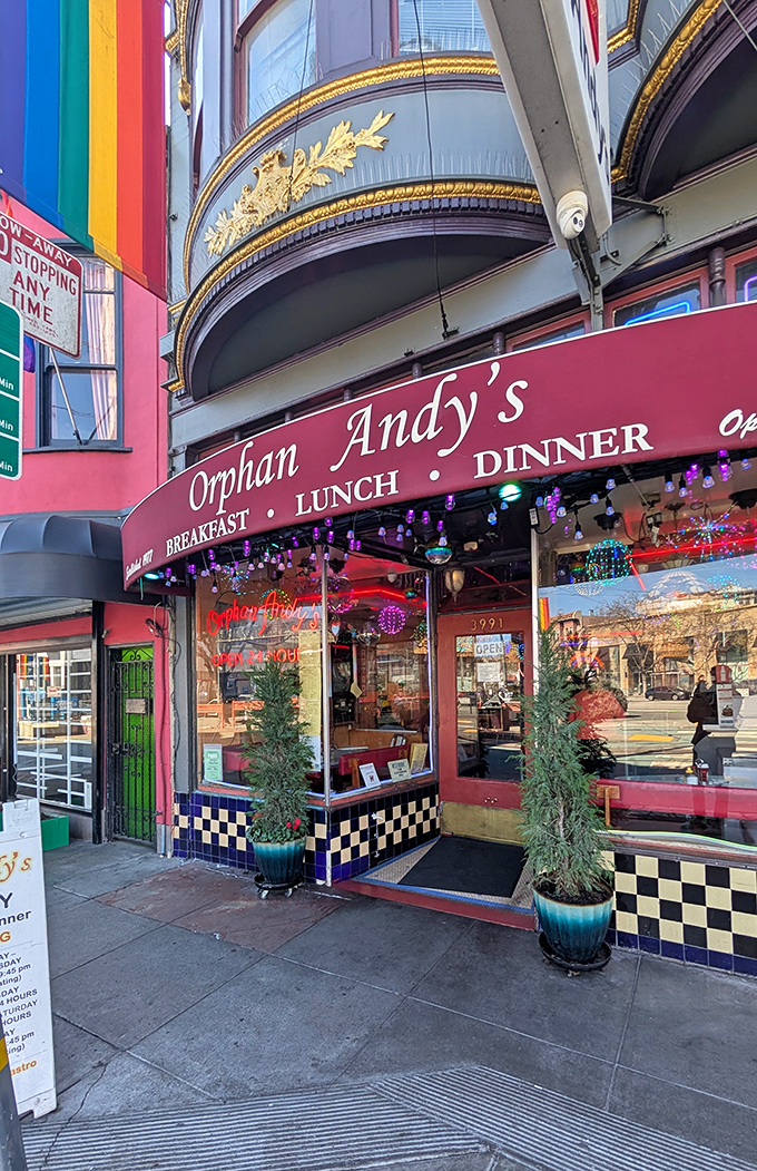 The iconic rainbow-striped entrance to Orphan Andy's beckons hungry visitors with its classic diner charm and vibrant Castro District energy.