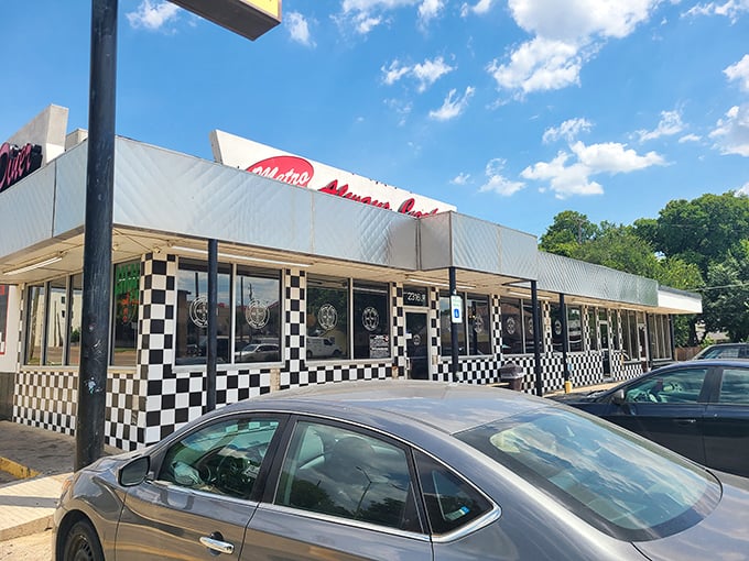 The black and white checkered exterior isn't just nostalgic design&mdash;it's a beacon signaling "real food ahead" to hungry Dallas travelers.