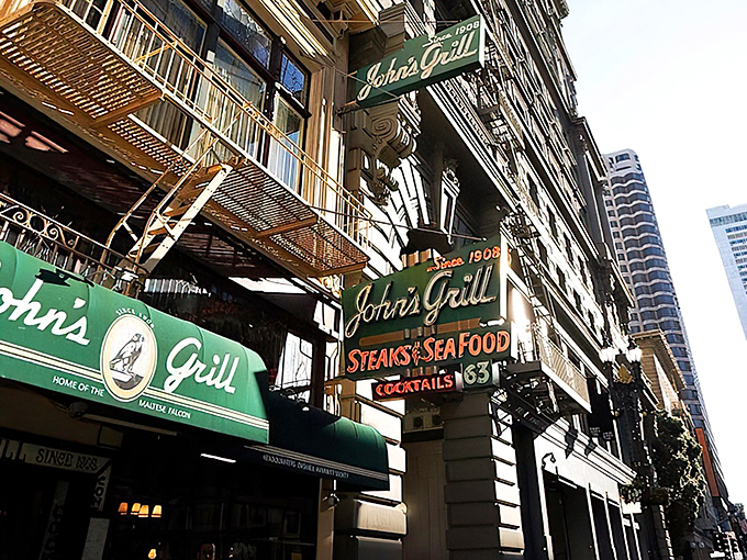 The iconic green and gold signage of John's Grill stands as a beacon of culinary history on Ellis Street, promising steaks, seafood, and stories since 1908.