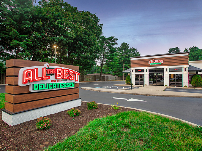 The neon sign beckons like a lighthouse for the hungry&mdash;All The Best Delicatessen's modern exterior promises delicious treasures within.