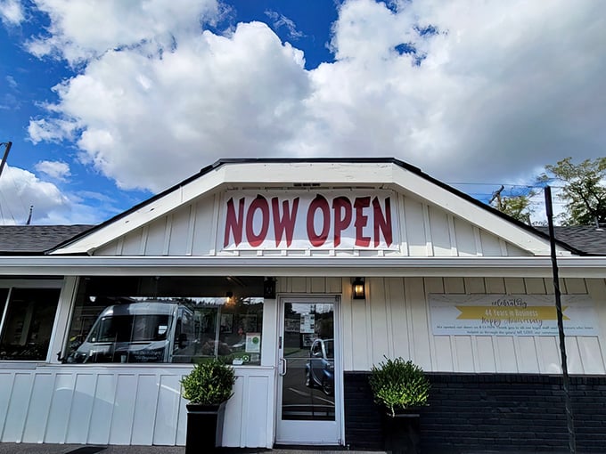 The classic white exterior of Banning's stands proudly under Oregon skies, American flag waving as if to say, "Good food happens here!"