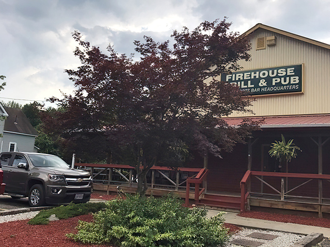 The red exterior of Rootstown Firehouse Grille & Pub stands like a beacon for hungry travelers, promising comfort and satisfaction within its welcoming walls.