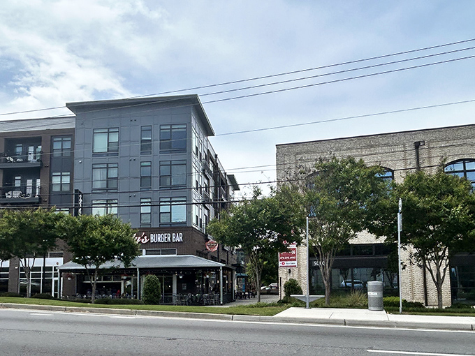 Bad Daddy's modern brick exterior beckons burger lovers with its inviting patio seating and string lights&mdash;urban comfort food paradise in Chamblee's evolving landscape.