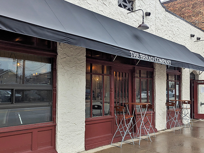 The classic black awning and textured white exterior of The Bread Company beckons like a European postcard come to life in downtown Urbana.