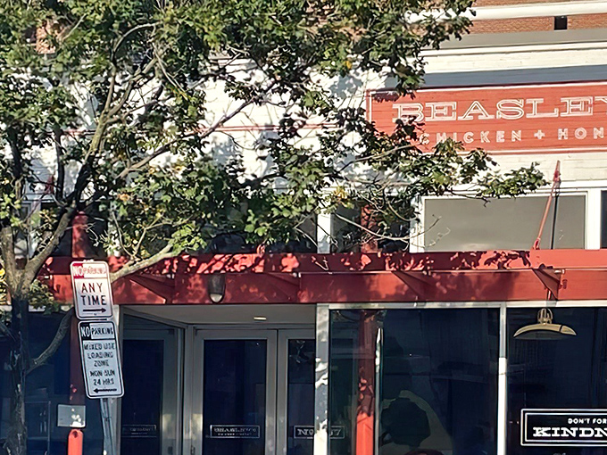 The iconic red awning of Beasley's Chicken + Honey beckons hungry visitors like a Southern lighthouse guiding ships to delicious shores.