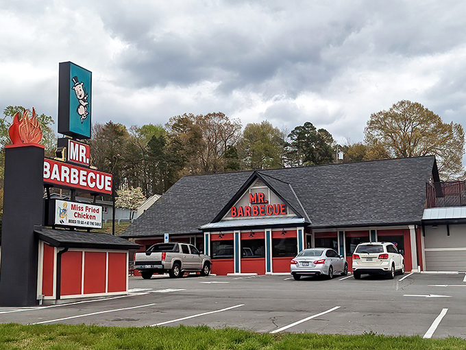 The iconic triangular "MR. BARBECUE" sign beckons hungry travelers like a smoky lighthouse guiding ships to delicious shores.