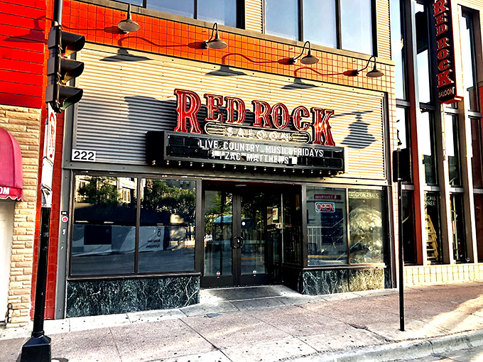 The bold red signage of Red Rock Saloon beckons like a neon oasis in downtown Madison, promising country comfort and culinary adventures within those glass doors.