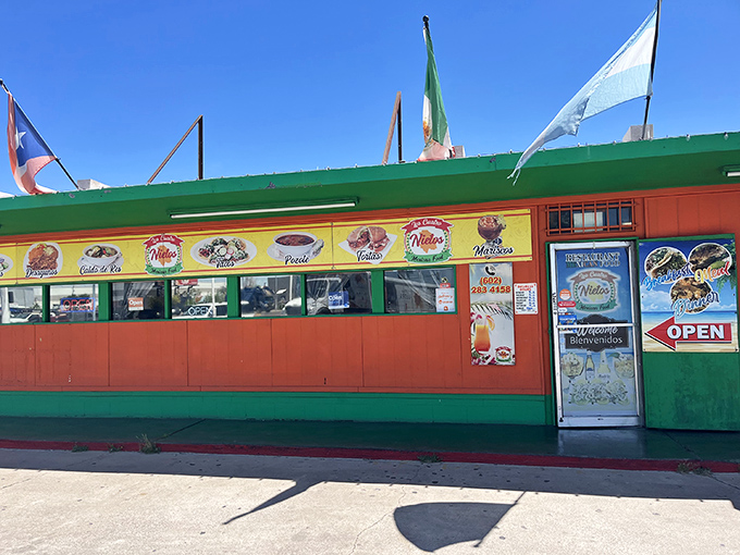 The vibrant exterior of Los Cuatro Nietos announces itself with colorful murals and flags, like a culinary carnival beckoning hungry passersby.
