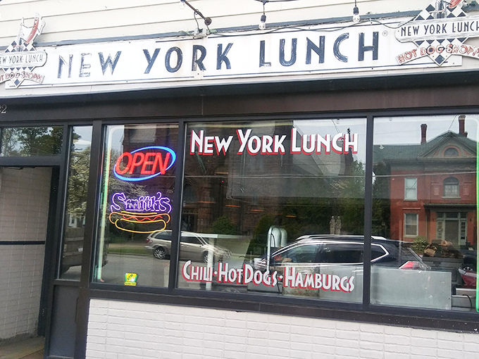 The unassuming storefront of New York Lunch beckons with neon promises of chili, hot dogs, and hamburgs&mdash;culinary poetry in simplicity.