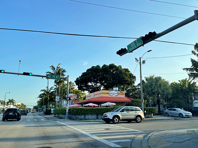 The corner of heaven and happiness! Dogma Grill's iconic yellow building with red awning stands like a beacon for hungry Miami locals seeking frank perfection.