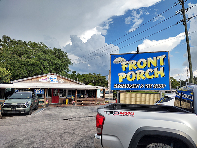 The unassuming exterior of Front Porch Restaurant proves once again that Florida's best culinary treasures often hide in plain sight, nestled under shady trees.