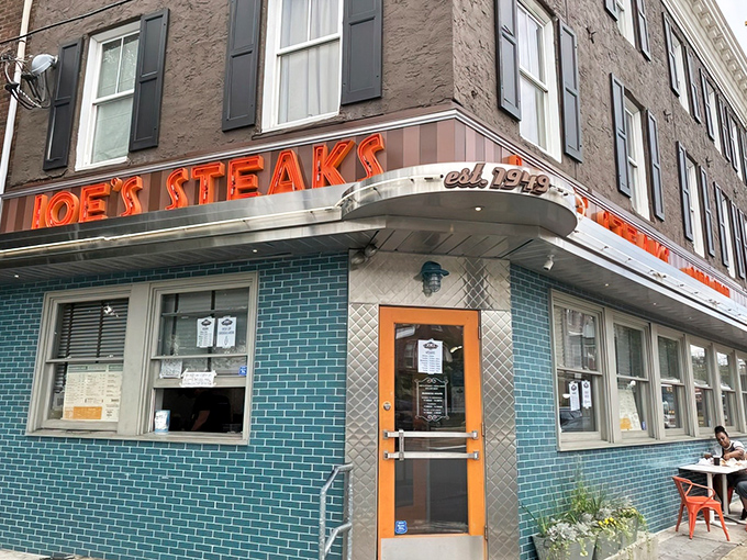 The neon glow of Joe's Steaks beckons like a lighthouse for hungry souls navigating Philadelphia's culinary waters.