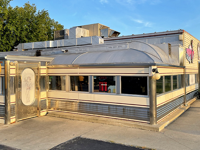 The classic stainless steel exterior of Nancy's Main Street Diner gleams in the sunlight, a time capsule of Americana waiting to transport hungry visitors back to simpler times.
