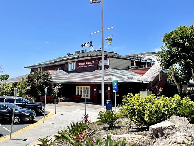 The Fish Market's nautical exterior stands like a welcoming lighthouse for hungry seafood pilgrims. Those flags aren't just for show&mdash;they're signaling "fresh catch ahead!"