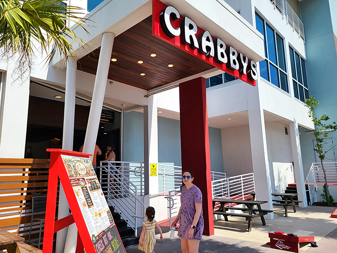 Modern coastal architecture meets Florida sunshine at Crabby's Dockside. The palm trees aren't just for show—they're nature's way of saying "vacation starts here."