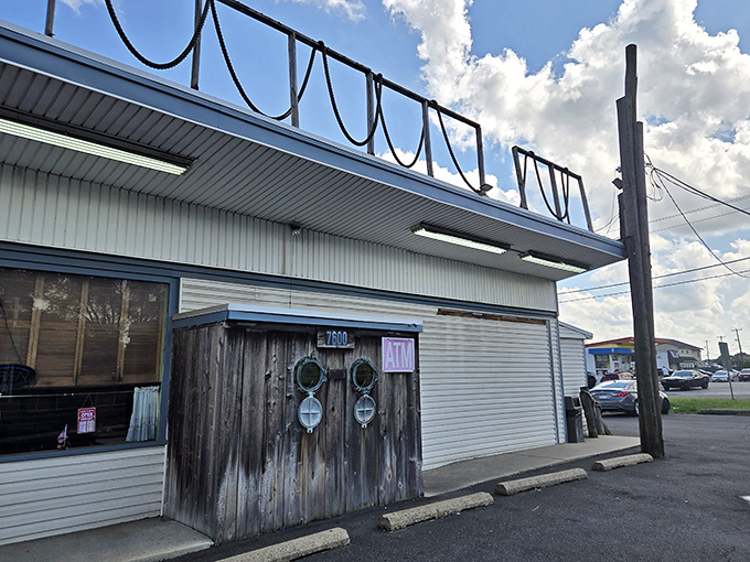 The nautical entrance to Under the Pier sets the perfect tone&mdash;wooden pilings, rope details, and a colorful sign promising seafood treasures await inside.