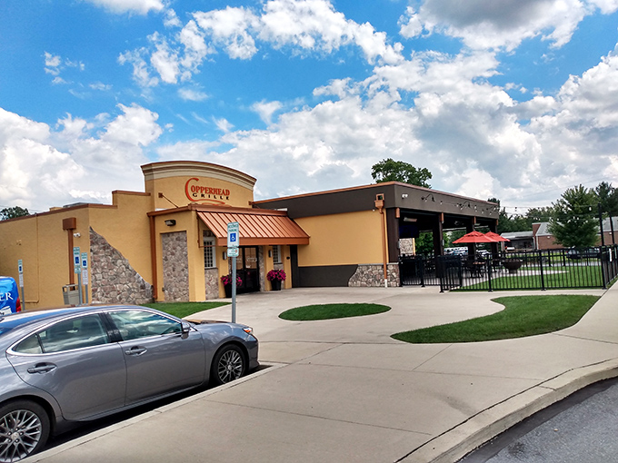 The warm beige exterior of Copperhead Grille welcomes hungry travelers like a culinary lighthouse guiding ships to delicious harbor. That patio practically begs for summer evenings.