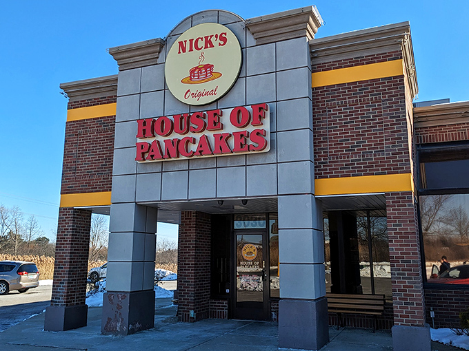 The iconic red and yellow sign of Nick's Original House of Pancakes stands like a breakfast lighthouse, guiding hungry souls to pancake paradise.