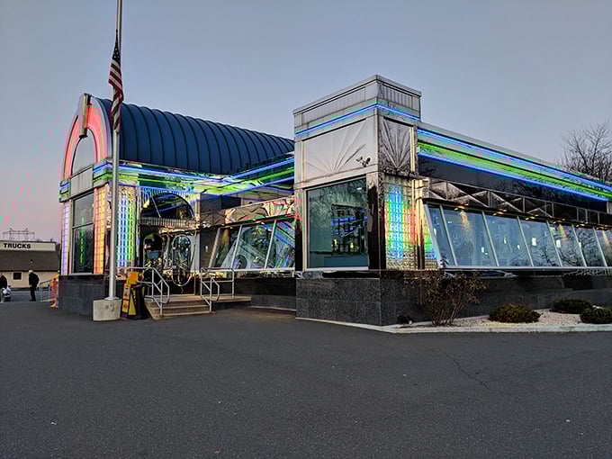 Neon dreams come true at twilight when the Americana Diner transforms into a glowing rainbow spaceship ready to beam you up for comfort food adventures.