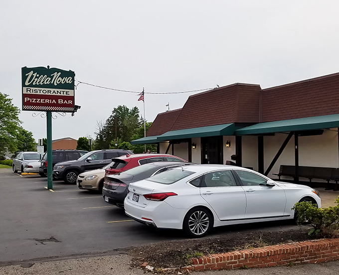 Villa Nova's charming Tudor-style exterior stands like a culinary time capsule, promising Italian delights behind its unassuming fa&ccedil;ade. The American flag waves a patriotic welcome.