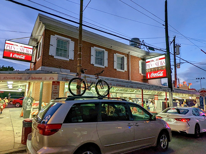 The crown jewel of South Philly! Pat's iconic sign glows like a neon North Star, guiding hungry pilgrims to the promised land of cheesesteak perfection.