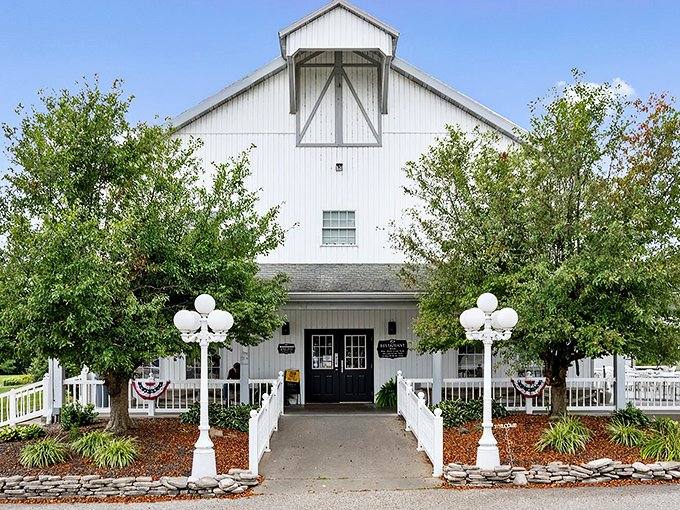 The pristine white exterior of Gasthof Amish Village welcomes visitors like a Norman Rockwell painting come to life, complete with charming lamp posts and a welcoming front porch. 