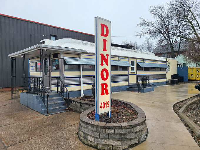 The gleaming silver exterior of Lawrence Park Dinor stands like a time machine in Erie, beckoning hungry travelers with its iconic vertical sign and promise of comfort food perfection.
