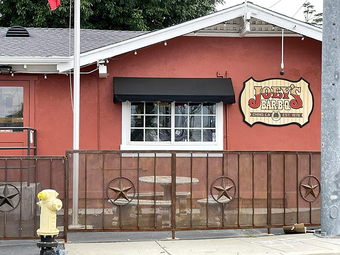 The unassuming terracotta exterior of Joey's BBQ in Chino, where rustic charm hints at the smoky treasures waiting inside.