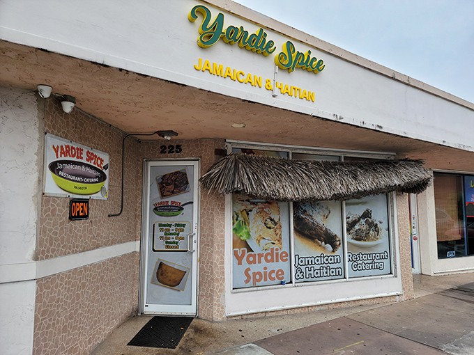 The unassuming exterior of Yardie Spice might fool you, but that thatched awning is your first clue&mdash;culinary paradise awaits behind these doors.