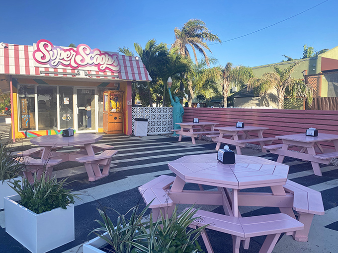 The pink-and-white striped awning of Super Scoops stands out like a beacon of sweetness on Treasure Island, promising frozen salvation from the Florida heat.