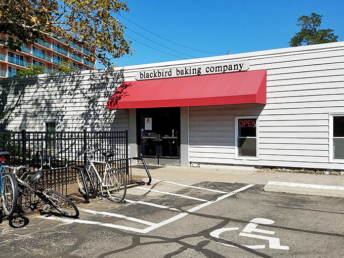 The unassuming exterior of Blackbird Baking Company, with its bright red awning, beckons carb enthusiasts like a lighthouse guiding ships to delicious shores.