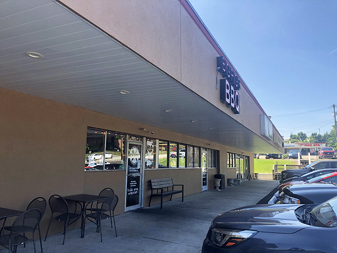 The bright red sign of Big Rig's BBQ stands out like a beacon for meat lovers, promising smoky delights within this unassuming Monroeville strip mall location.
