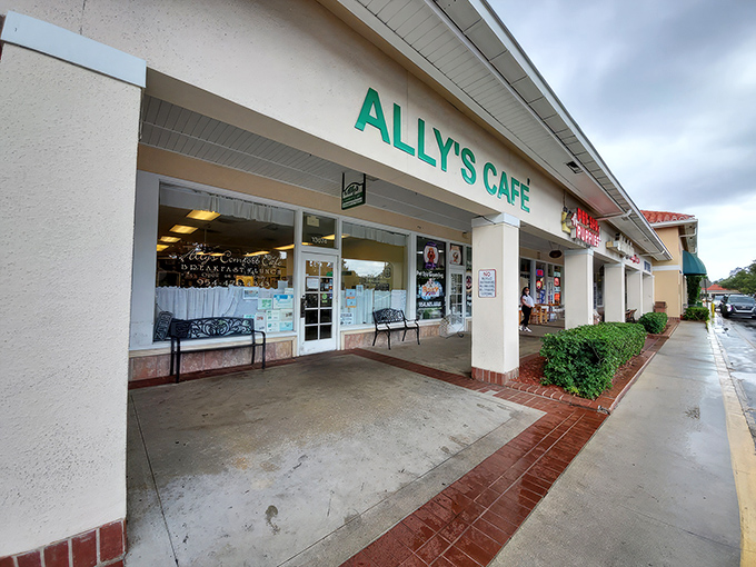 The unassuming storefront of Ally's Comfort Cafe, where lace curtains and a simple sign hide culinary treasures that would make any food pilgrim rejoice.