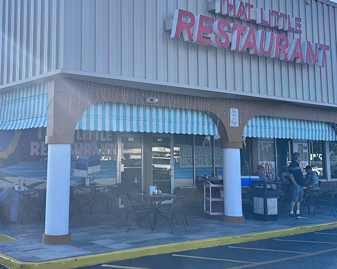 The bright red sign beckons like a lighthouse for hungry souls. That Little Restaurant's unassuming strip mall exterior hides culinary treasures within.