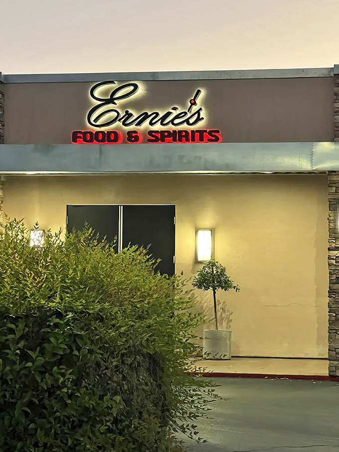 The glowing sign of Ernie's Food & Spirits beckons like a culinary lighthouse, promising delicious refuge from everyday dining disappointments.