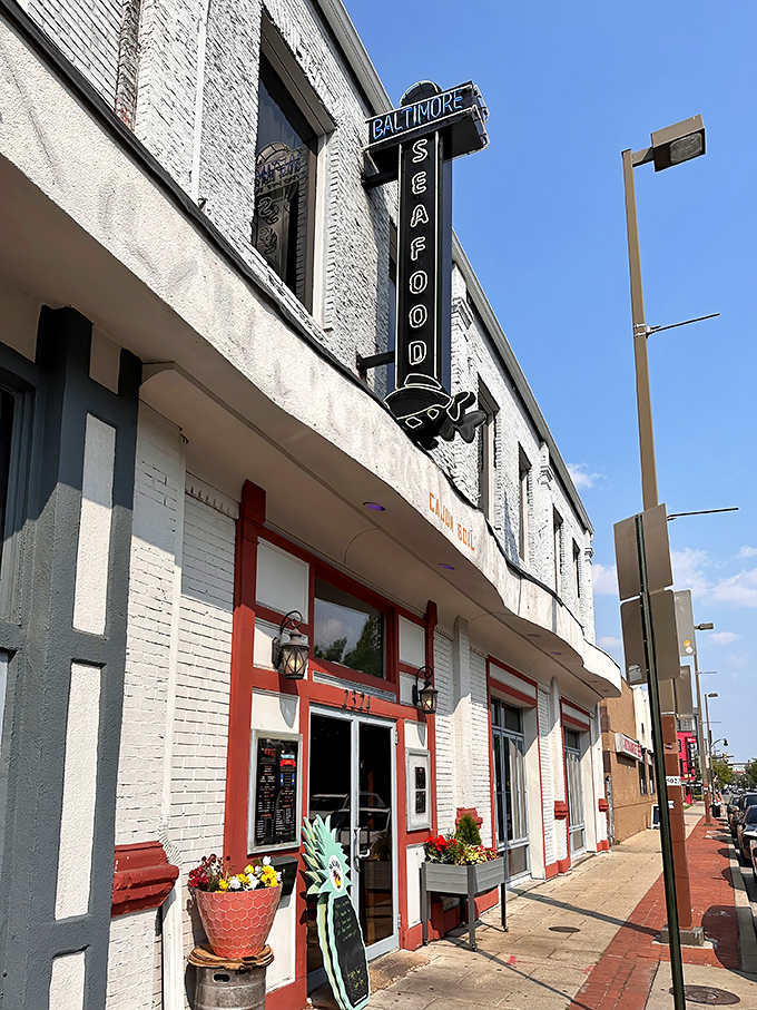 The iconic neon green crab sign beckons seafood lovers like a maritime lighthouse on Baltimore's urban shore.