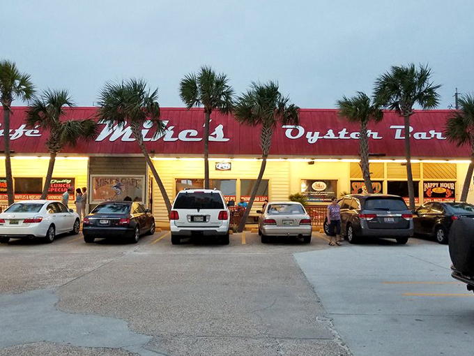 The iconic red roof and palm trees of Mike's Cafe and Oyster Bar stand like a culinary lighthouse, beckoning seafood lovers from across the Panhandle.