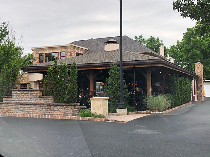 Stone meets sophistication at Blue Grillhouse's exterior, where Pennsylvania charm gets dressed up for a night on the town. Evergreen sentinels stand guard at this culinary fortress.