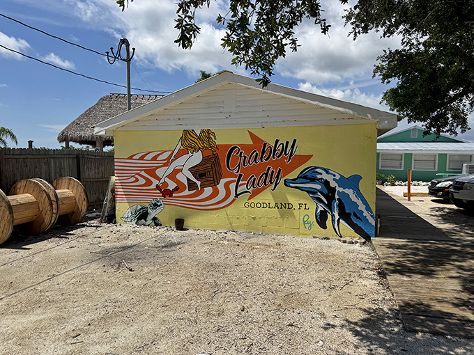 The sunshine-yellow exterior of Crabby Lady announces itself with all the subtlety of a Jimmy Buffett concert—complete with dolphins, dogs, and enough coastal charm to fill a beach novel.